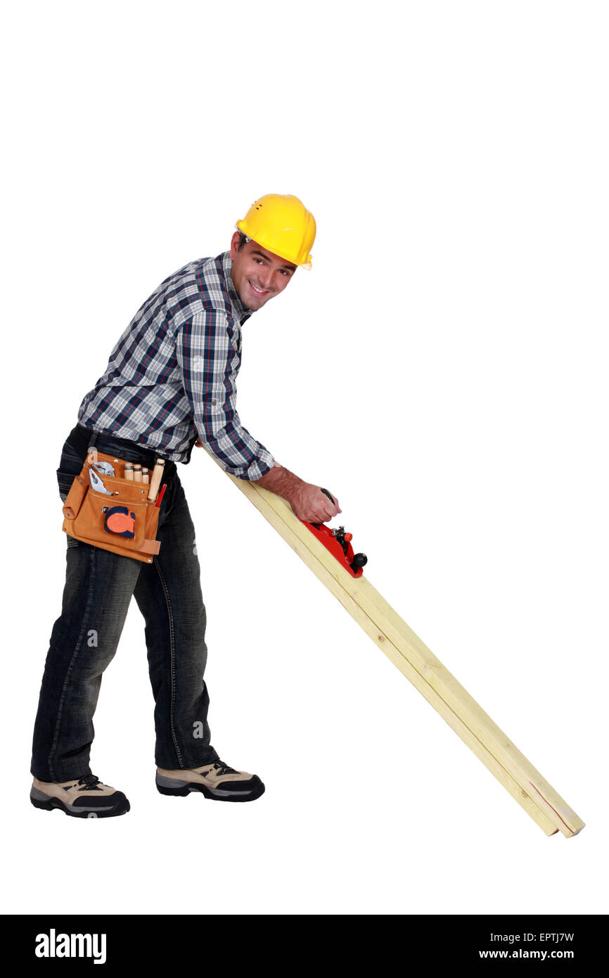 Carpenter using a plane Stock Photo - Alamy