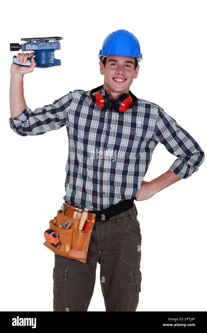 Young handyman holding electric sander Stock Photo - Alamy