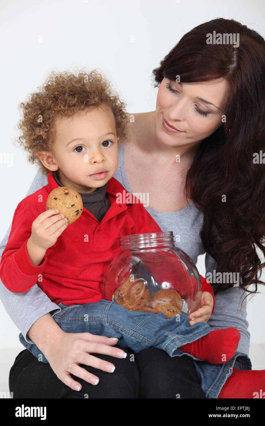 Cute child eating cookies Stock Photo - Alamy