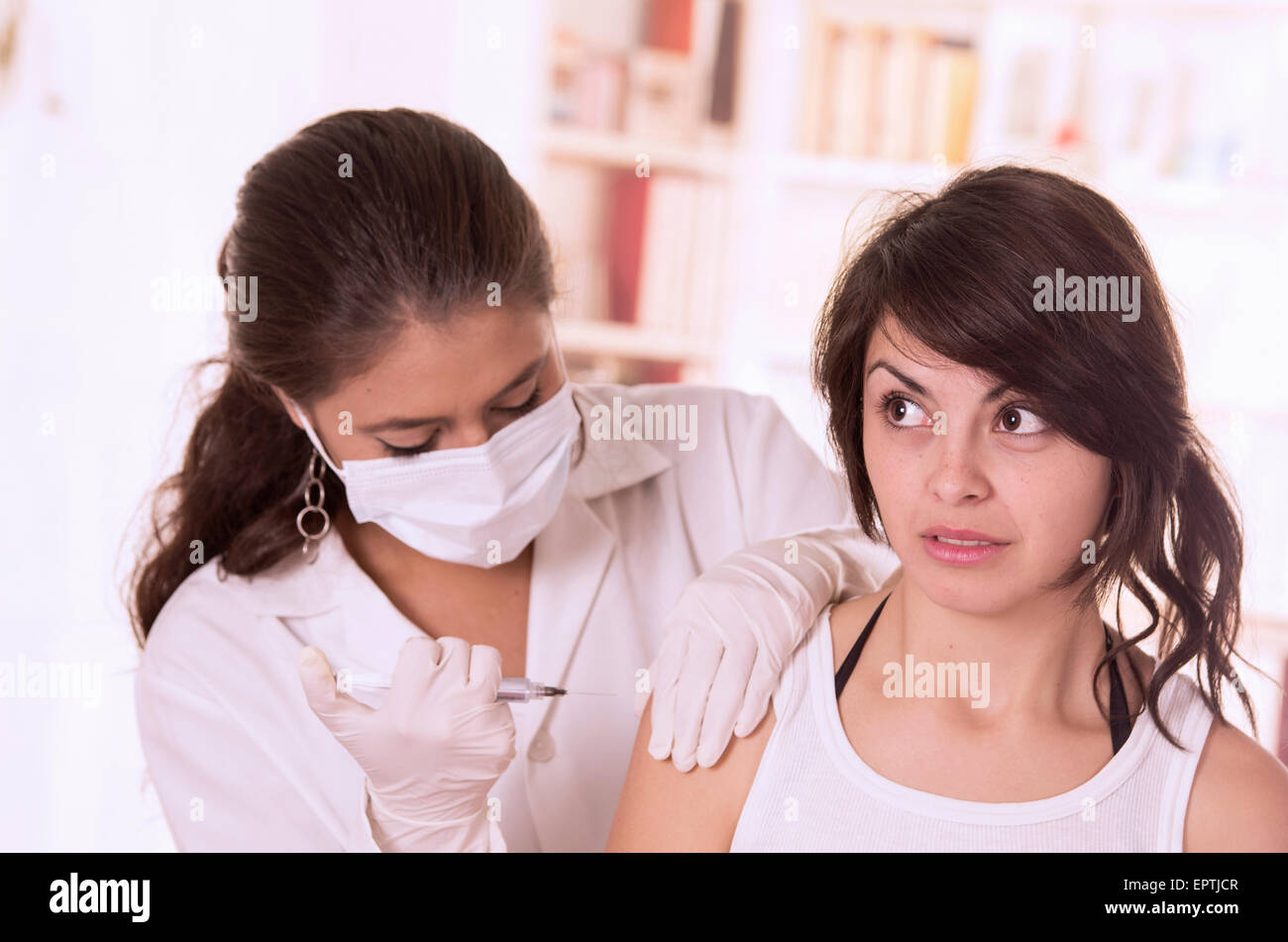 Doctor ready with injection holding patients arm Stock Photo - Alamy