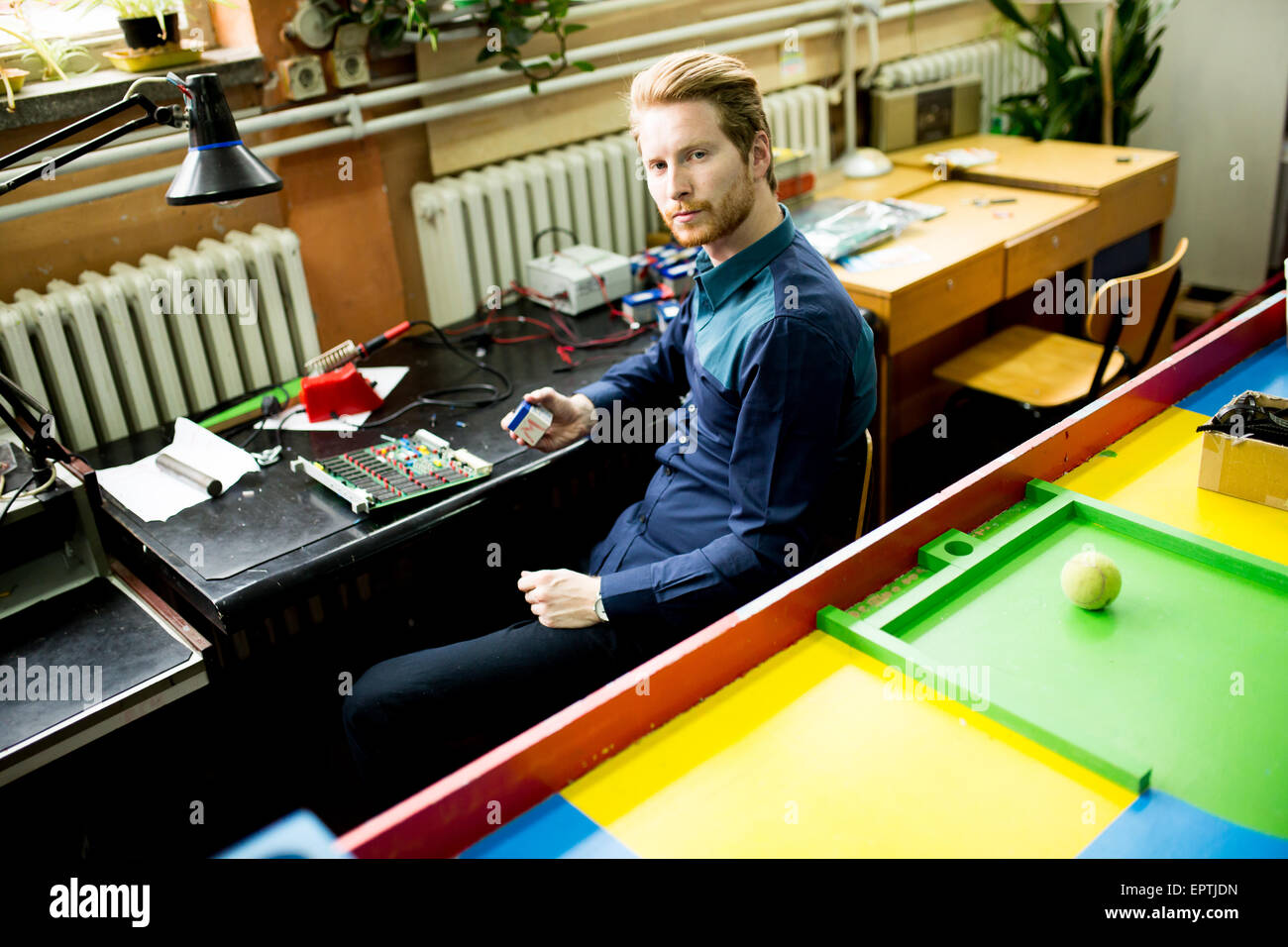 Young man in electronics workshop Stock Photo - Alamy