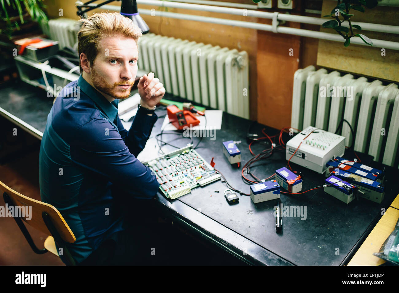 Young man in electronics workshop Stock Photo - Alamy