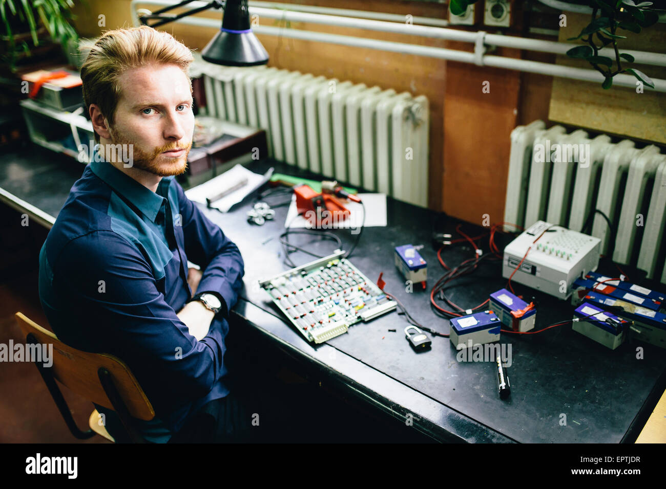 Young man in electronics workshop Stock Photo - Alamy