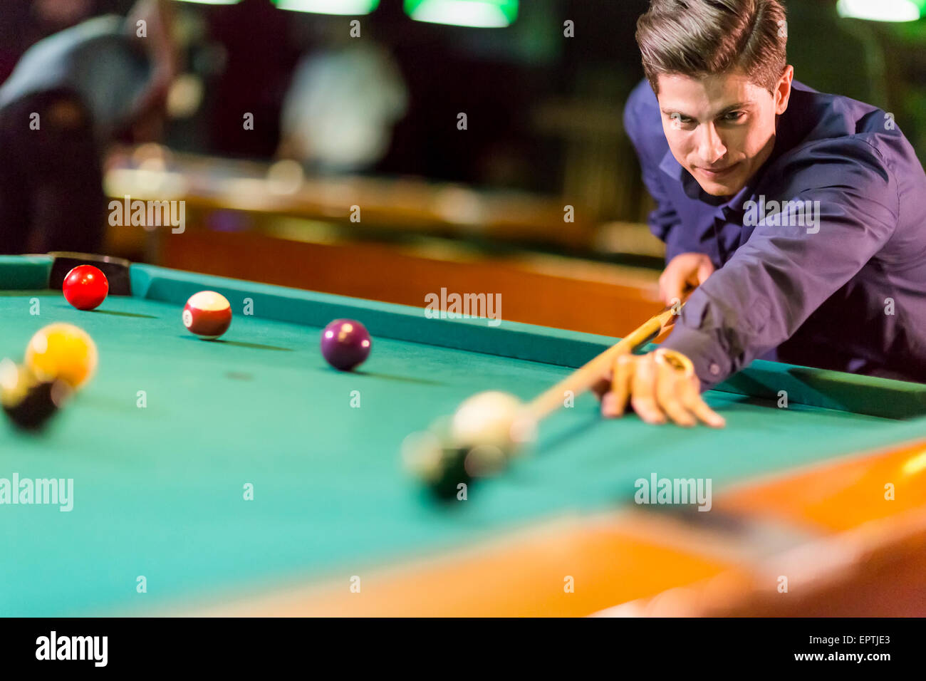 Young man playing pool Stock Photo - Alamy