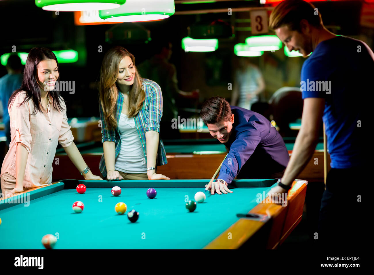 Young people playing pool Stock Photo - Alamy