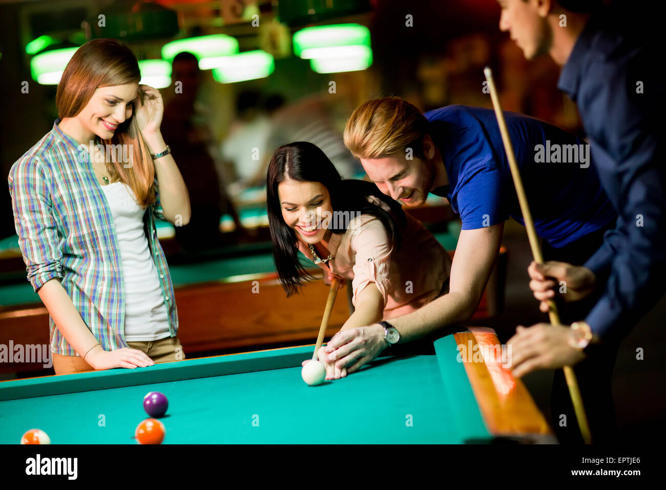Young people playing pool Stock Photo - Alamy