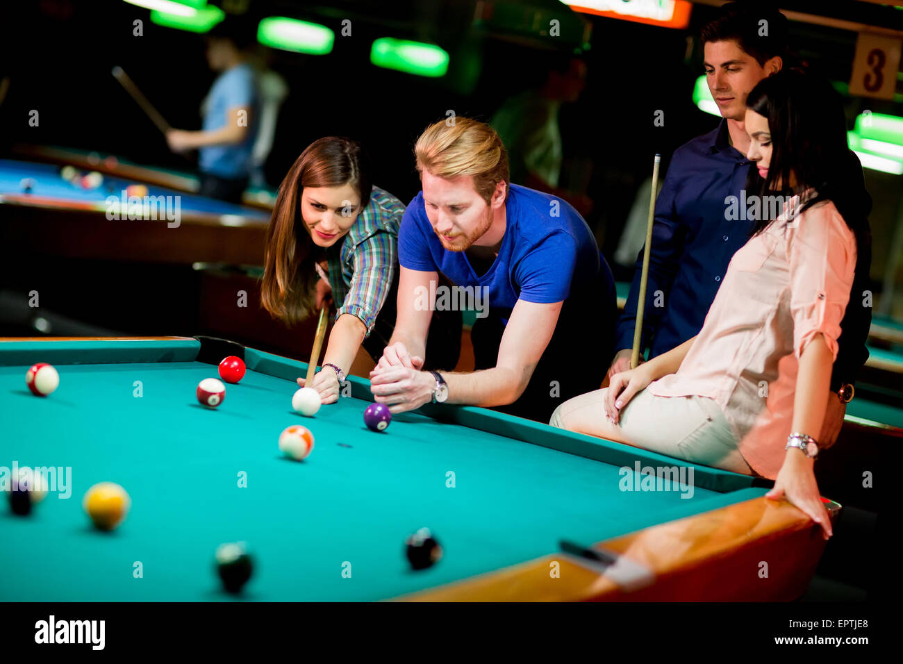 Young people playing pool Stock Photo - Alamy
