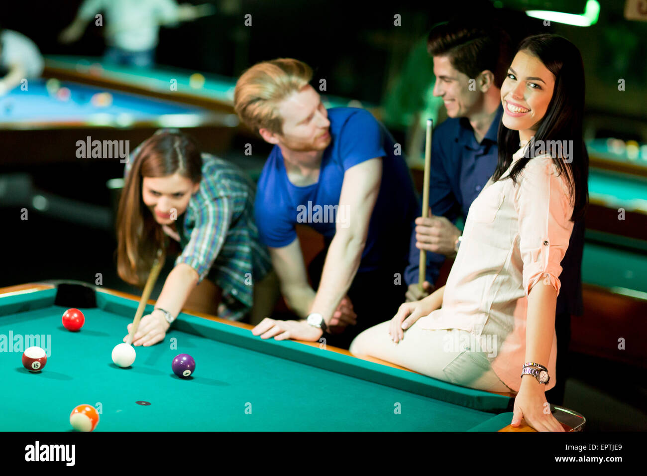 Young people playing pool Stock Photo - Alamy
