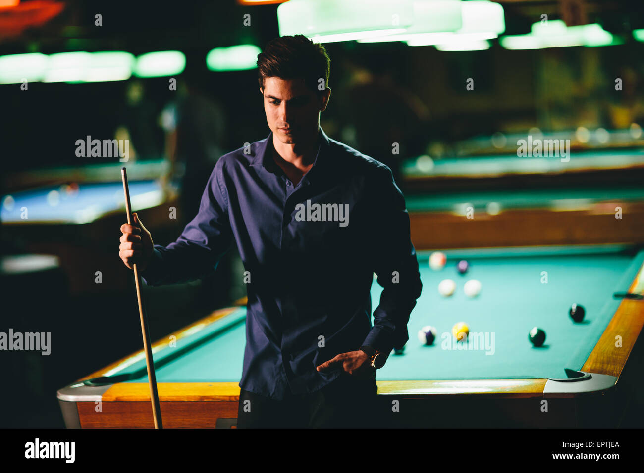 Young man playing pool Stock Photo - Alamy