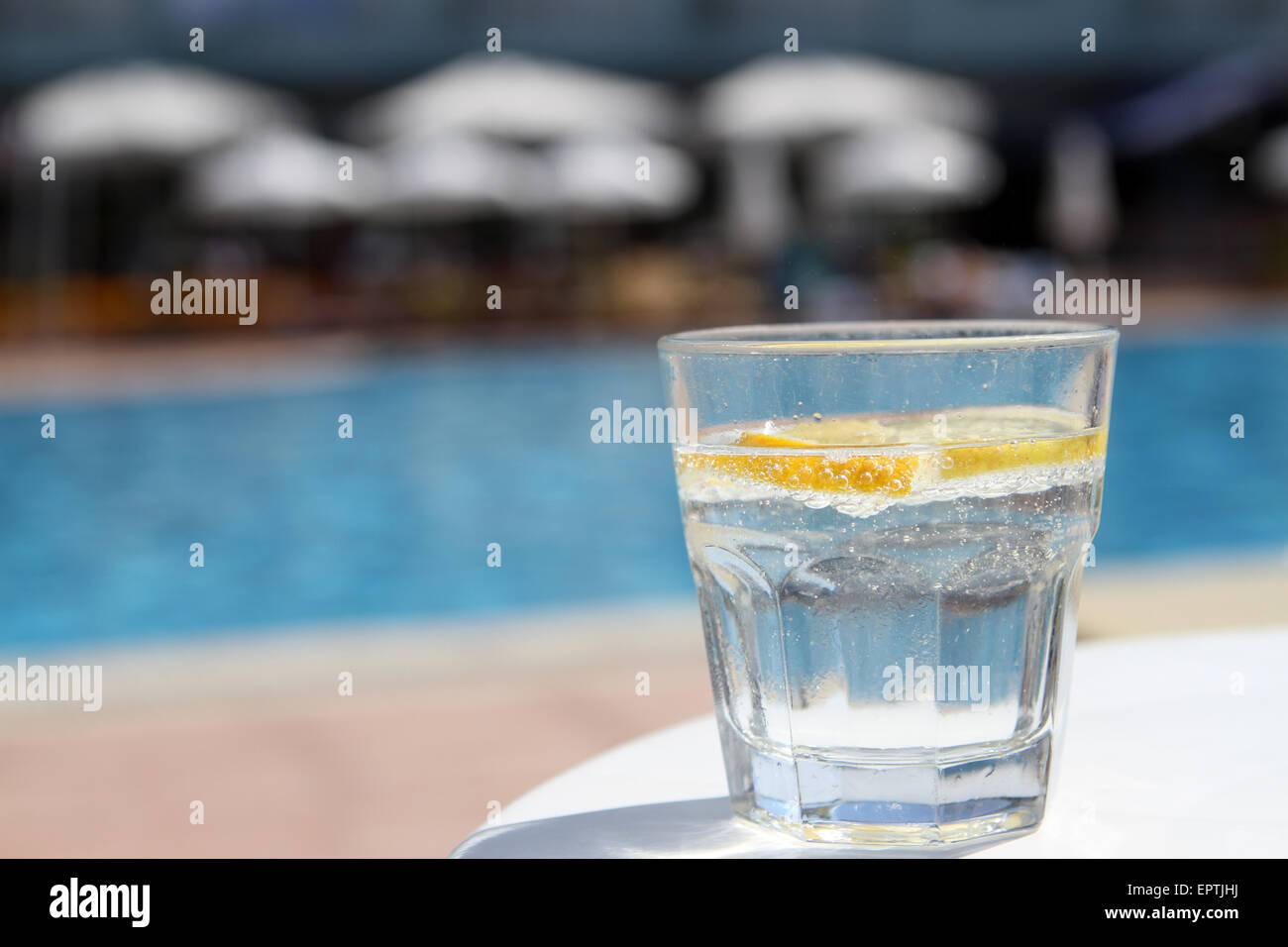 Fresh water with lemon cocktail near pool on the table Stock Photo - Alamy