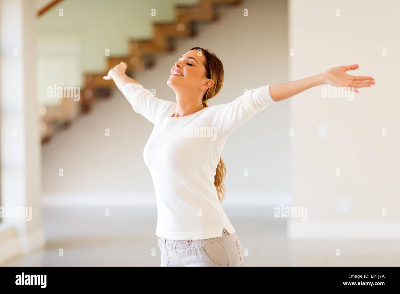 happy young woman arms open in her new house Stock Photo - Alamy