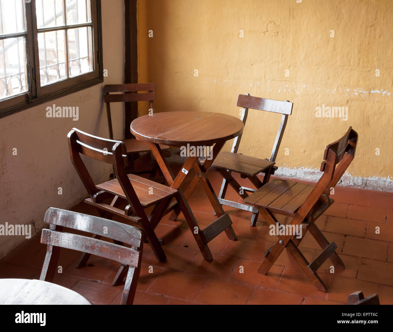 Photography of a round wooden table with chairs hi-res stock ...