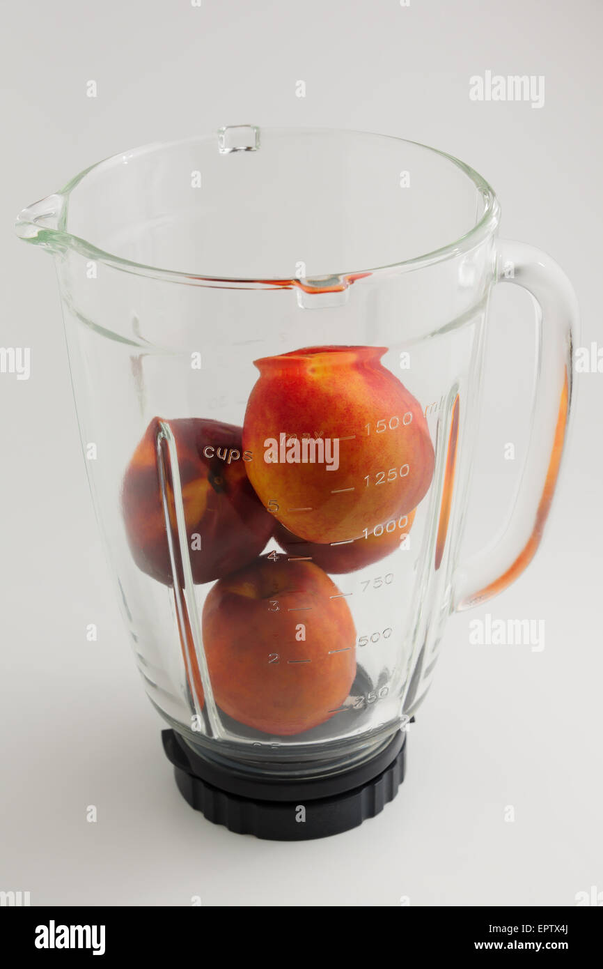fruit lies in a glass flask of a blender on a white background Stock ...