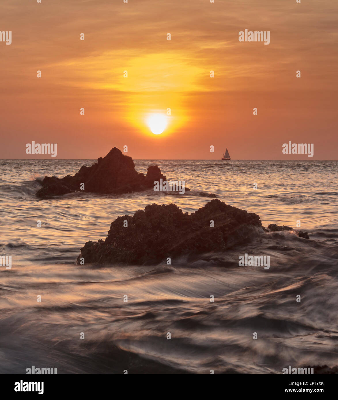 A sail boat at sunset Stock Photo - Alamy