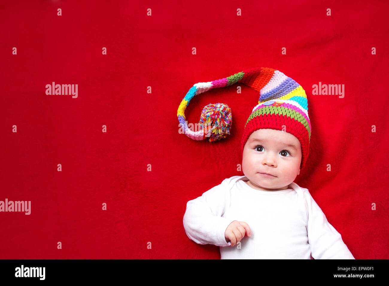 Baby in red and white hat Stock Photo - Alamy