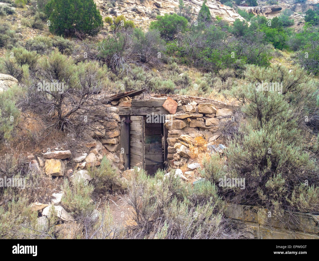 Wooden entrance to stone building built in the side of a hill Stock ...