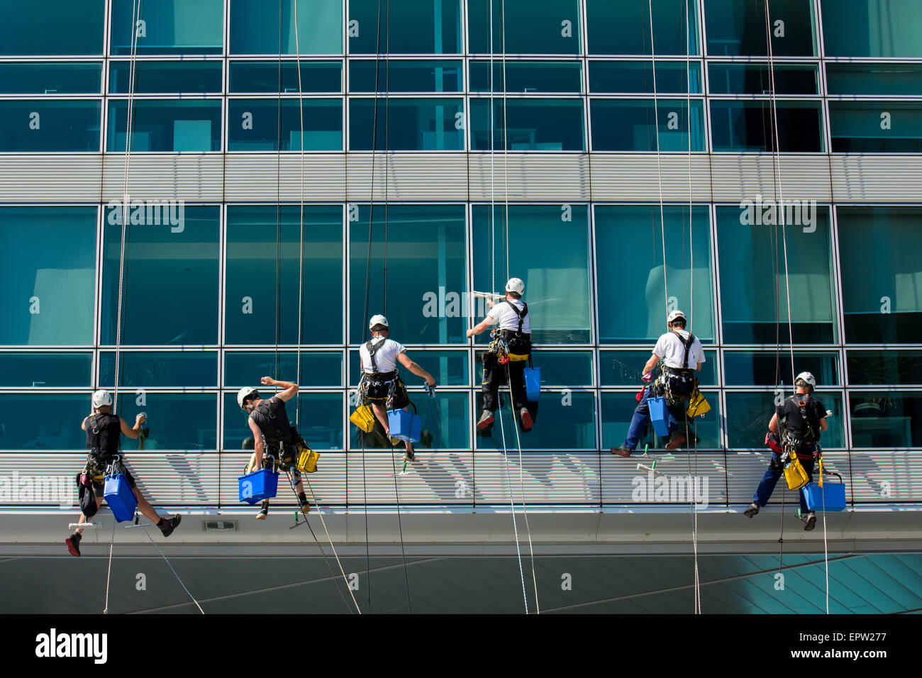 Team Of Climbing Workers On Office Building Stock Photo - Alamy