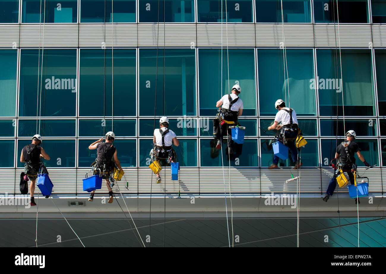 Team Of Climbing Workers On Office Building Stock Photo - Alamy