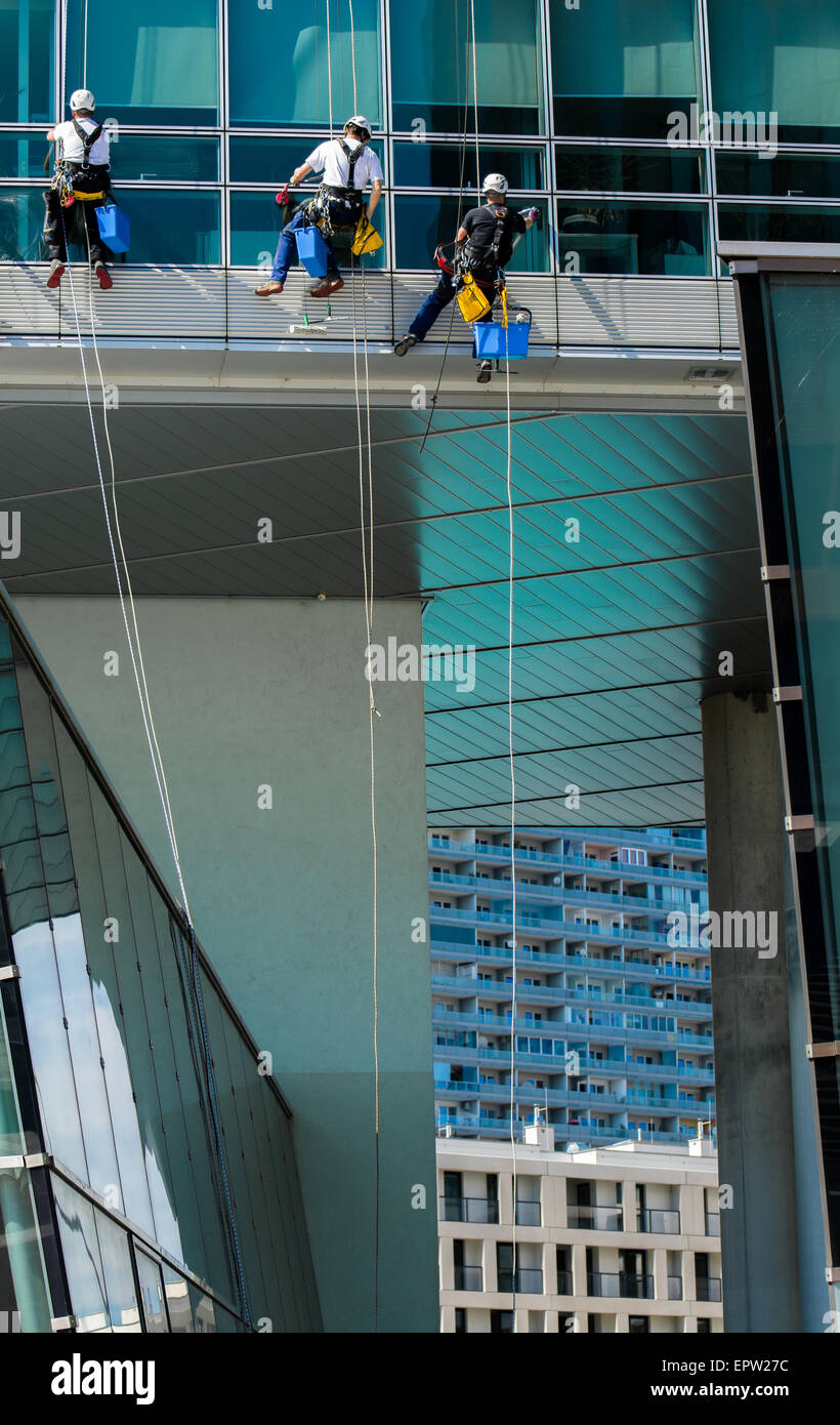 Team Of Climbing Workers On Office Building Stock Photo - Alamy
