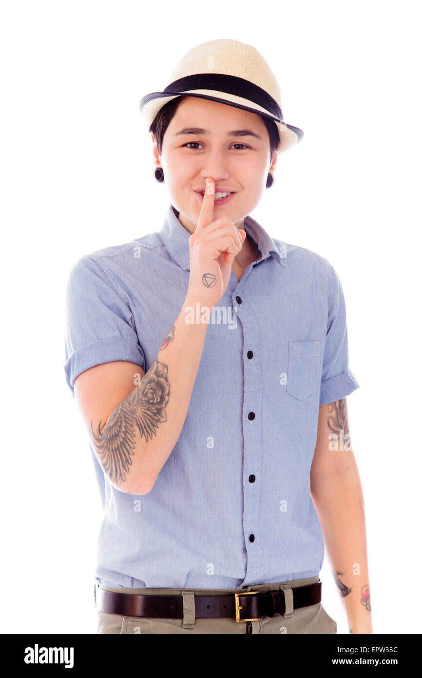 Young woman standing with finger on lips Stock Photo - Alamy