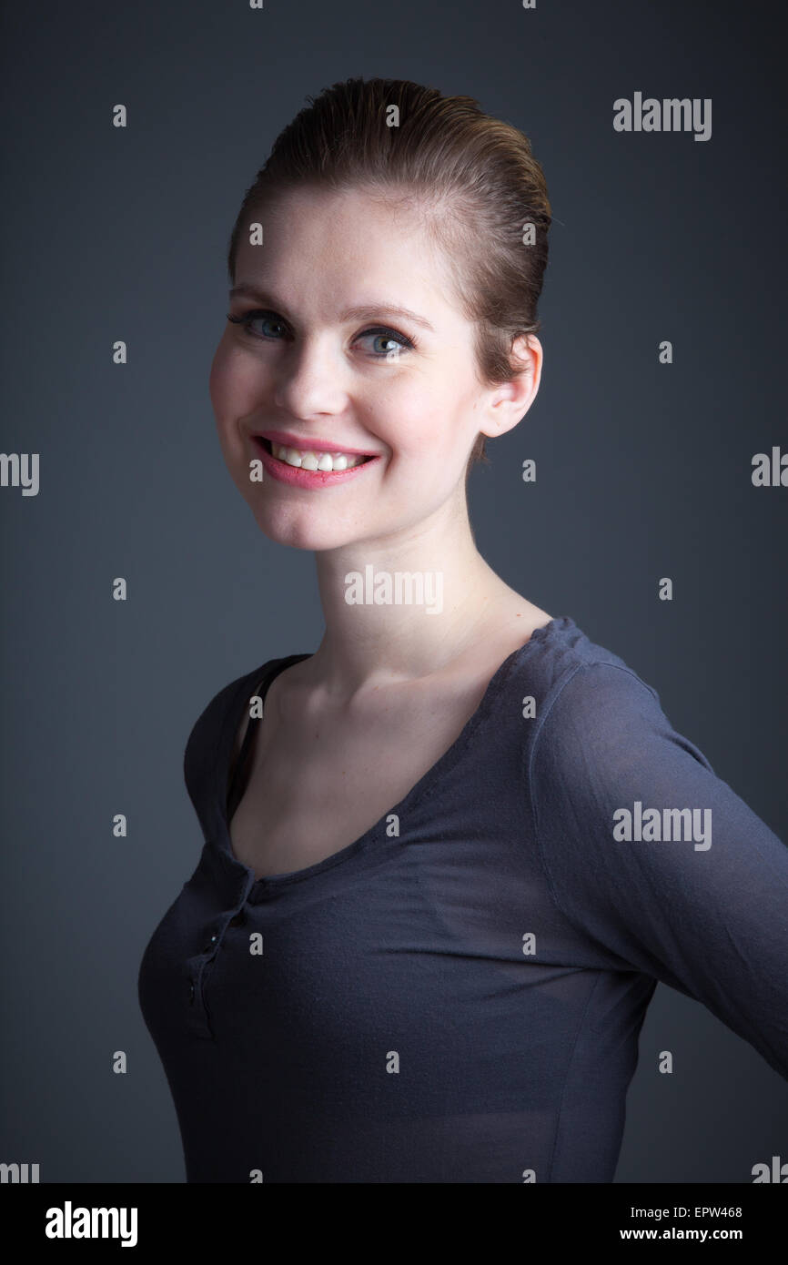 Attractive caucasian woman in her 30 isolated on a grey background ...