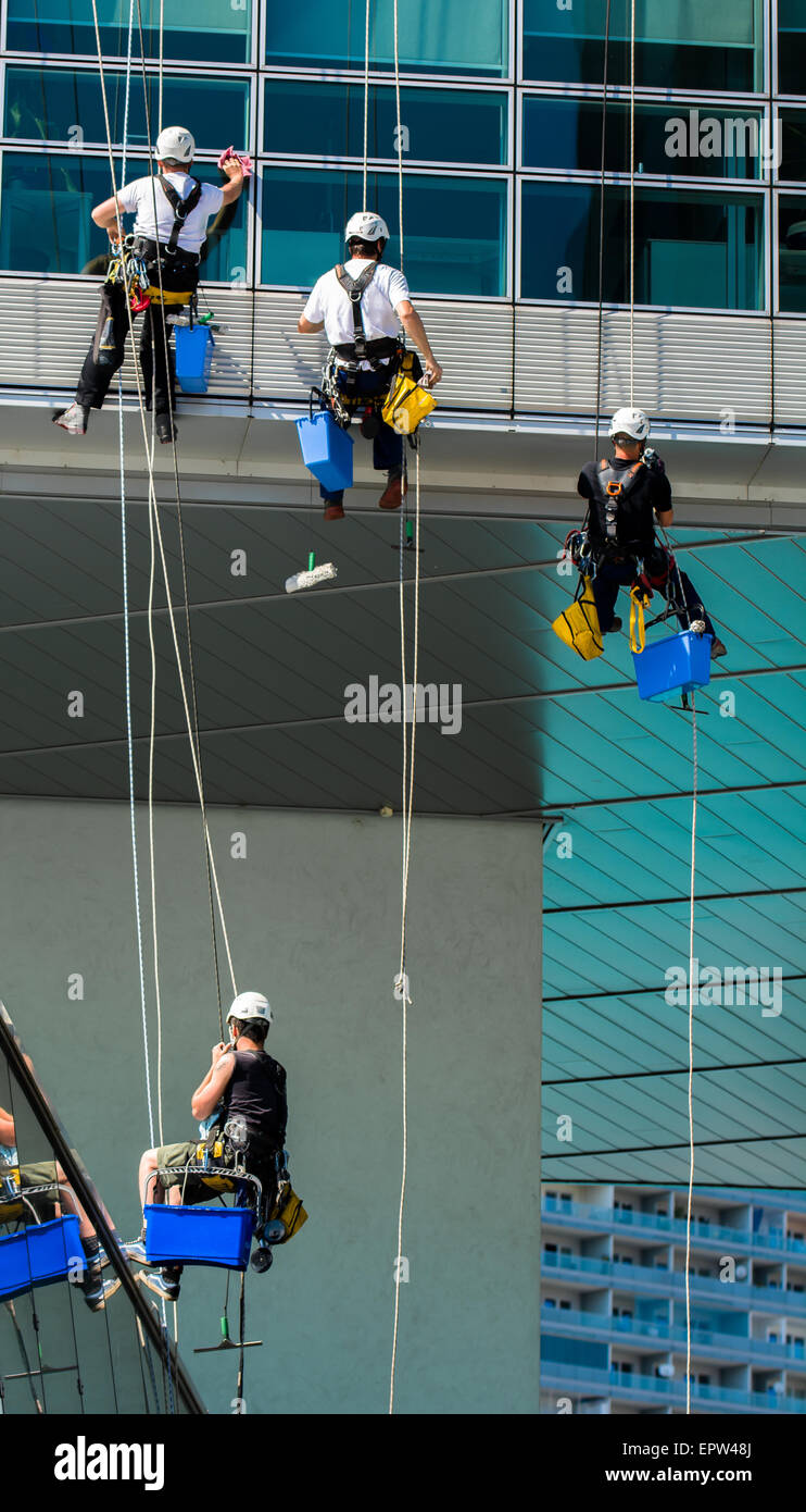 Team Of Climbing Workers On Office Building Stock Photo - Alamy