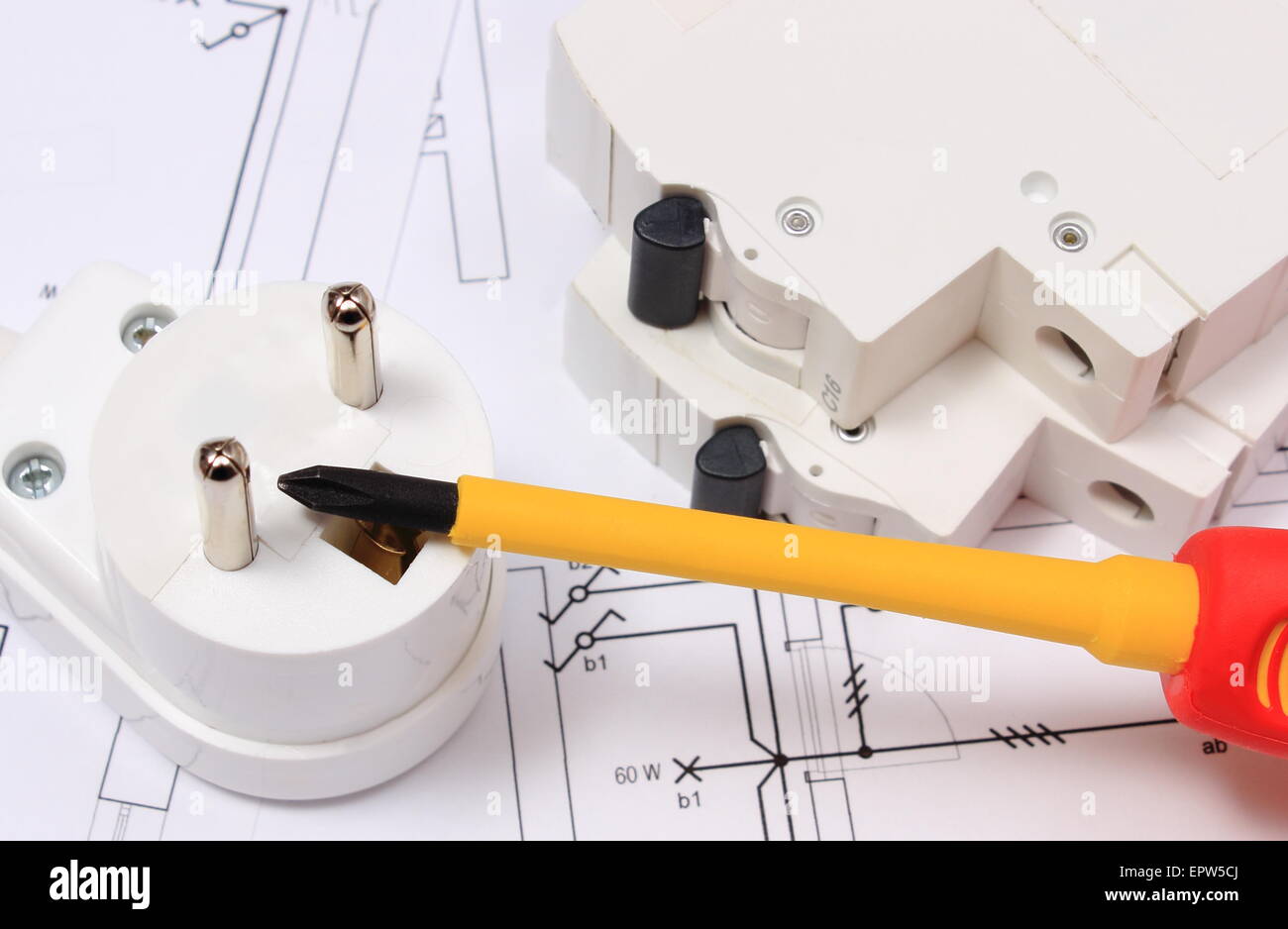 Screwdriver, work tools, electric plug and fuse lying on construction ...