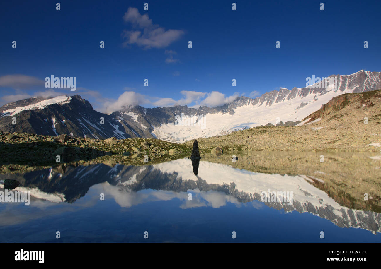 Lake Bergsee in the Swiss mountains, with reflections of the Alps in it ...