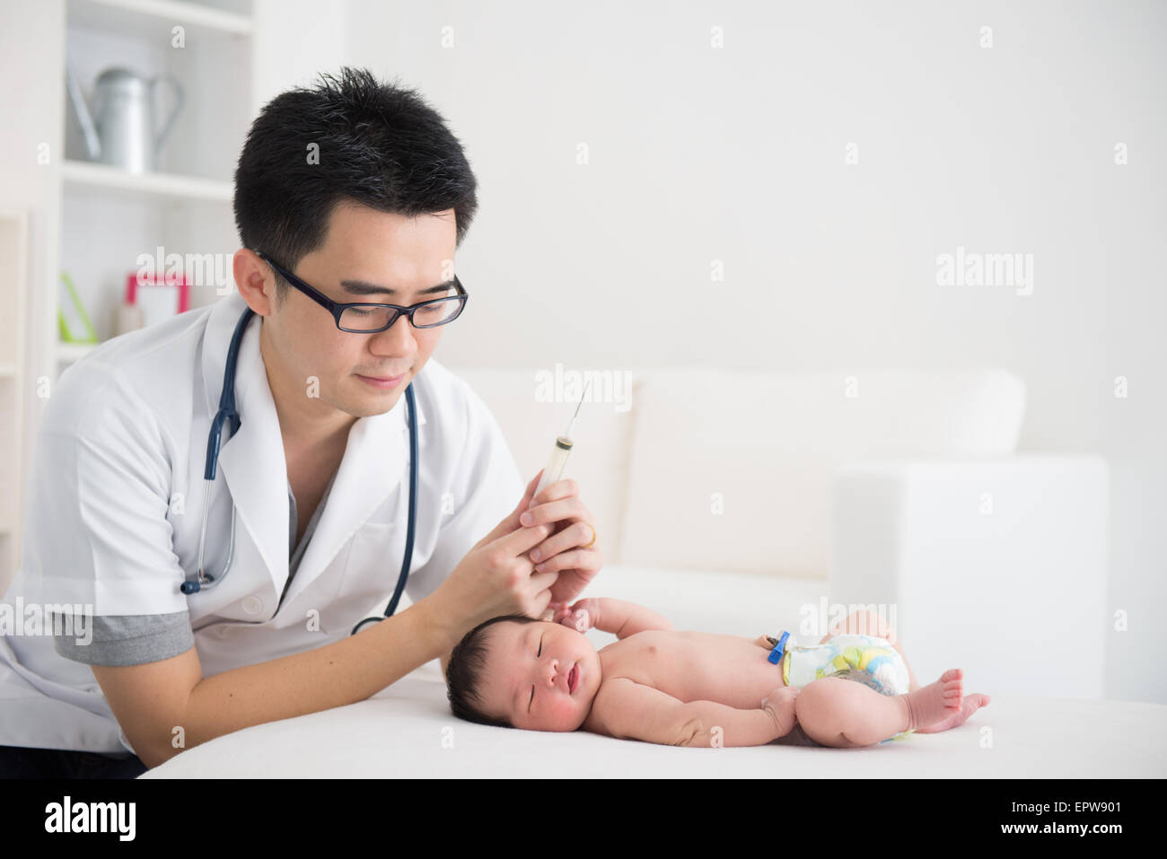 Good looking asian doctor and newborn baby on the clinic Stock Photo ...