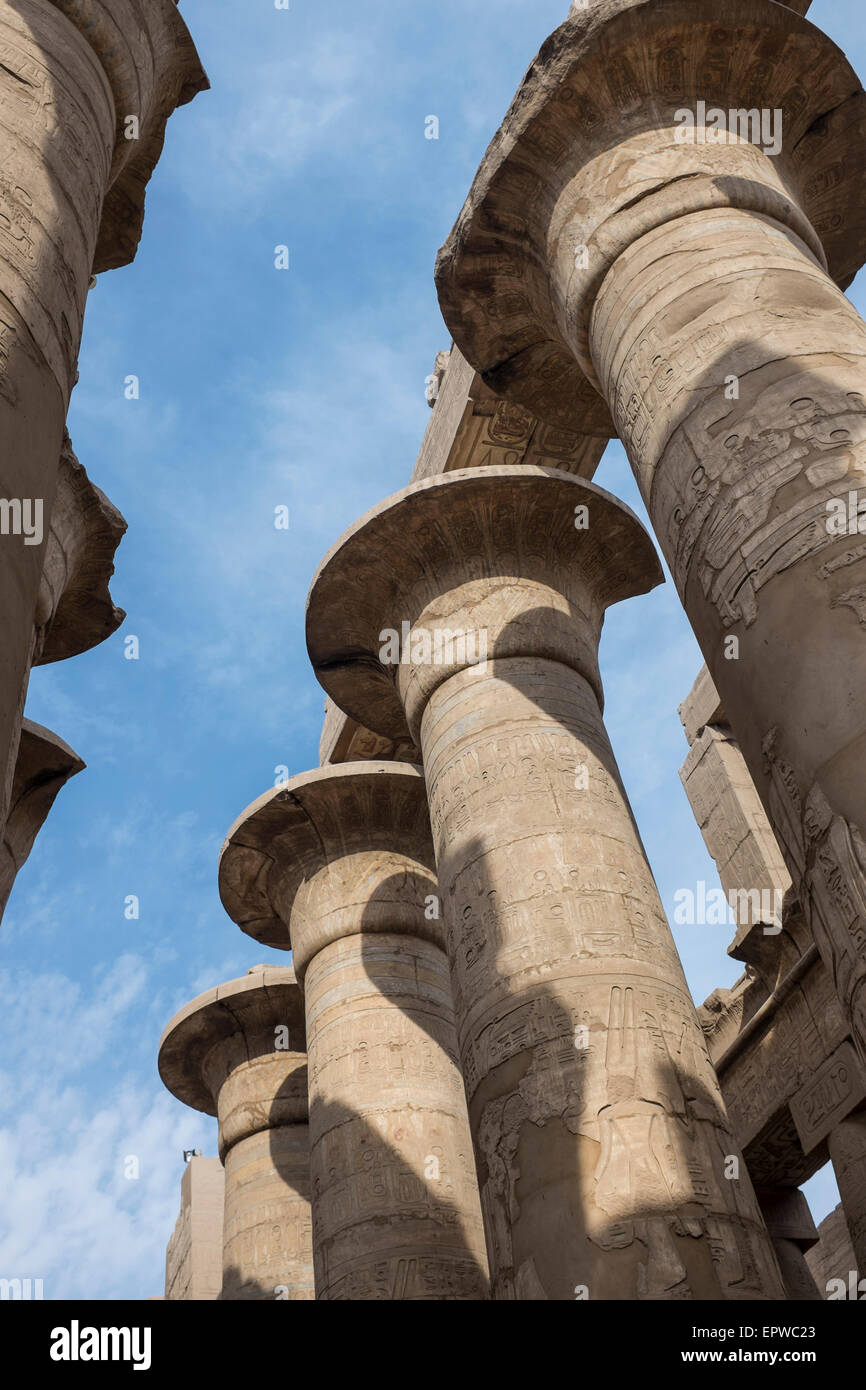 Giant carved columns against a vivid blue sky in the Great Hypostyle ...