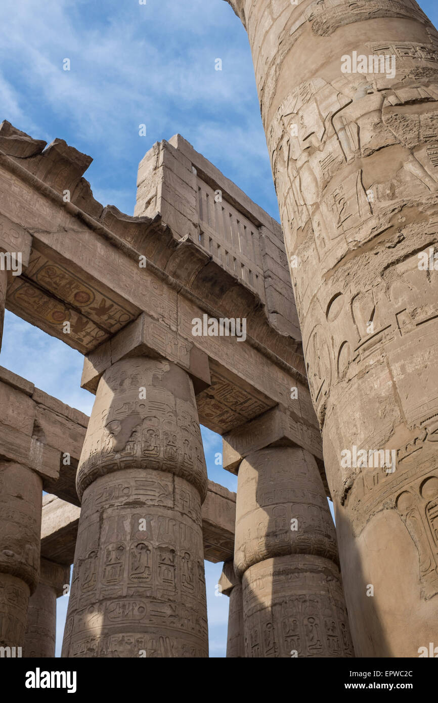 Giant carved columns against a vivid blue sky in the Great Hypostyle ...