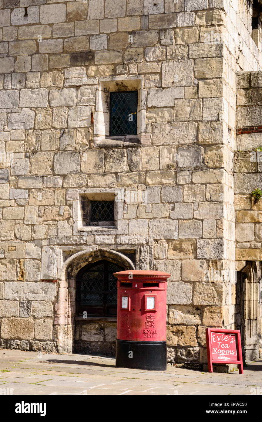 The ancient gate house at Gillygate, York. A red Royal Mail post box in ...
