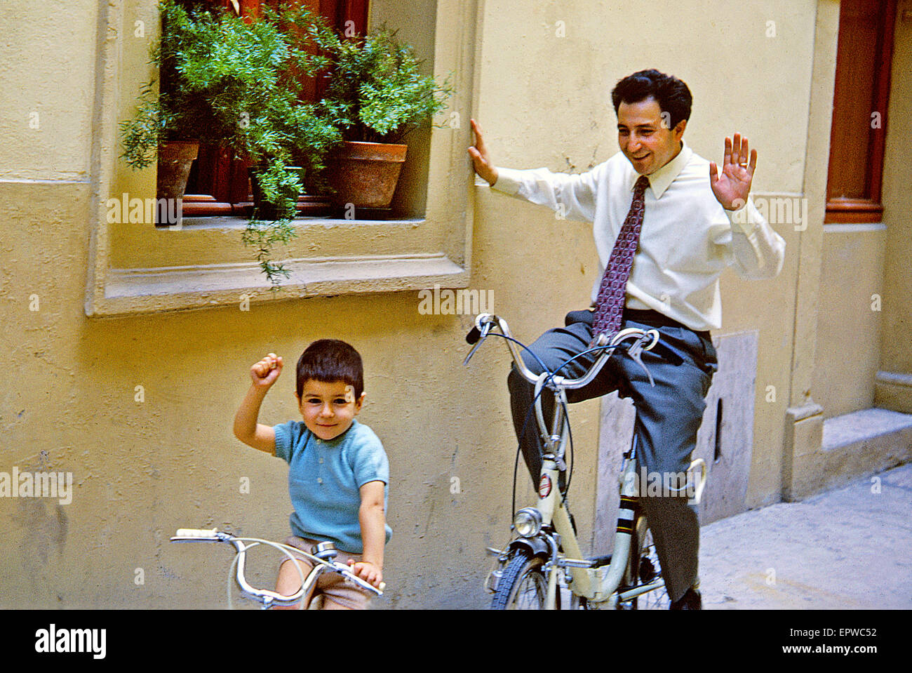 Spanish father and son on bicycles,1970's Stock Photo - Alamy
