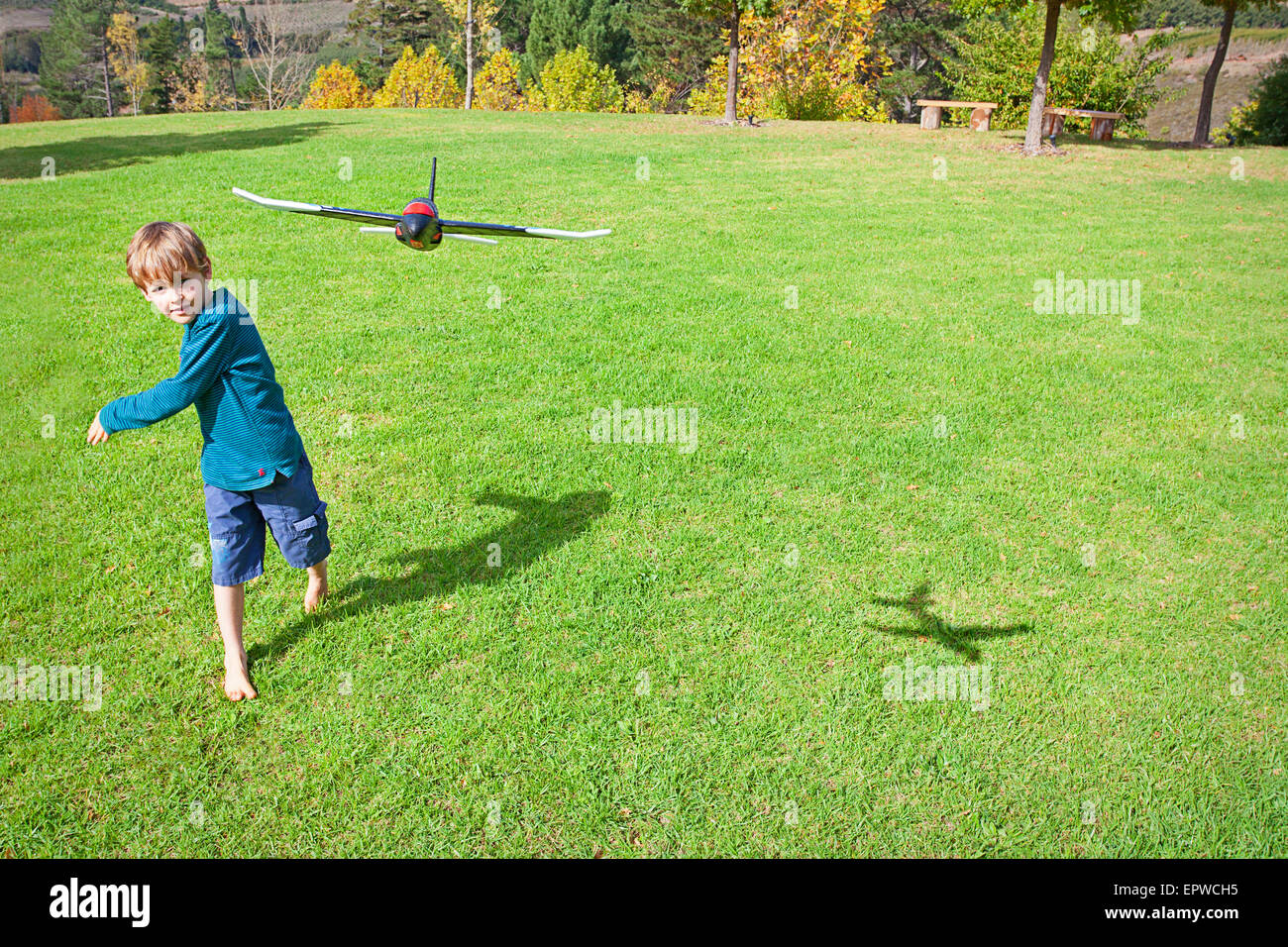 Young boy throwing a model plane Stock Photo - Alamy
