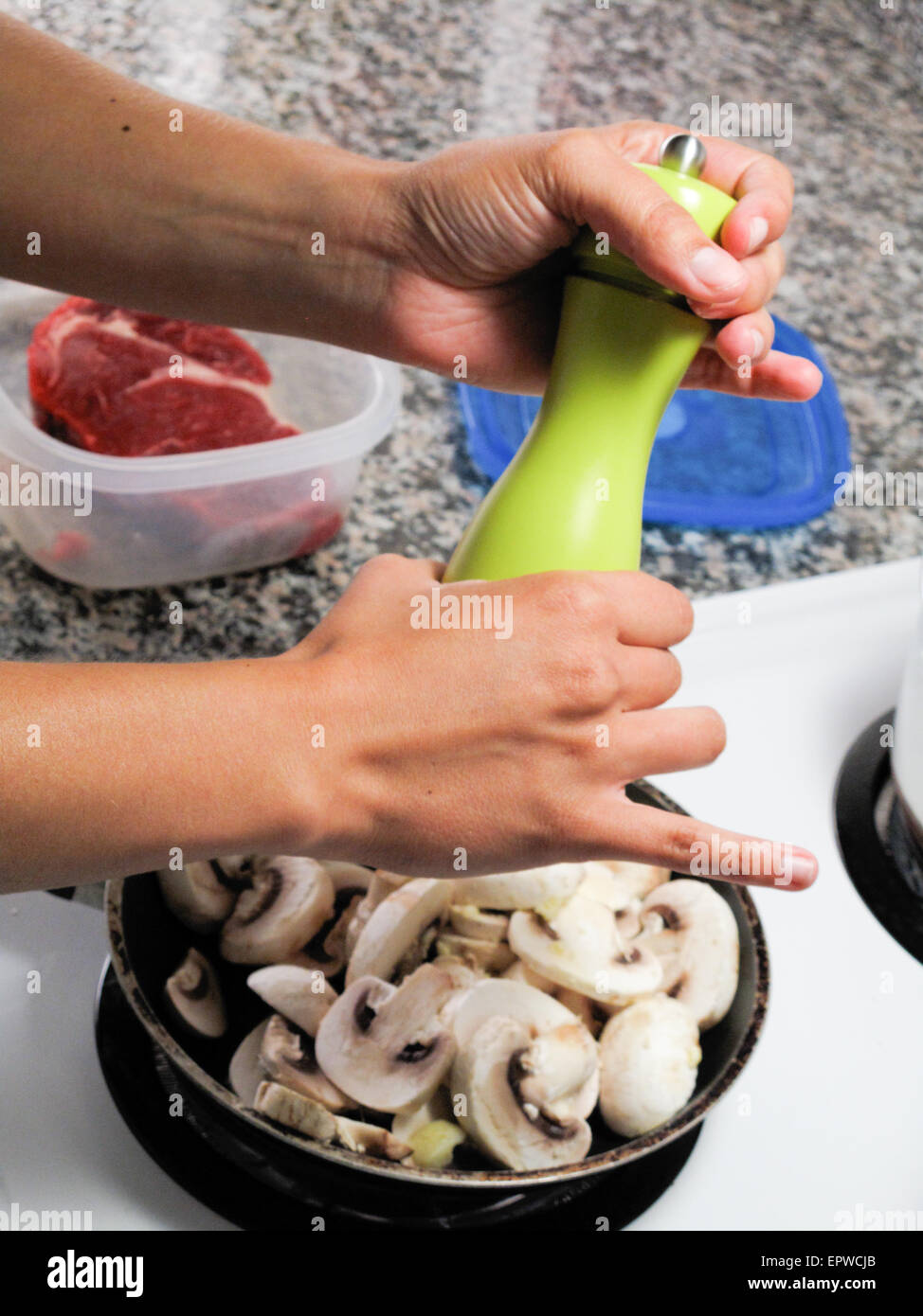 Close-up of human's hand cooking food Stock Photo - Alamy