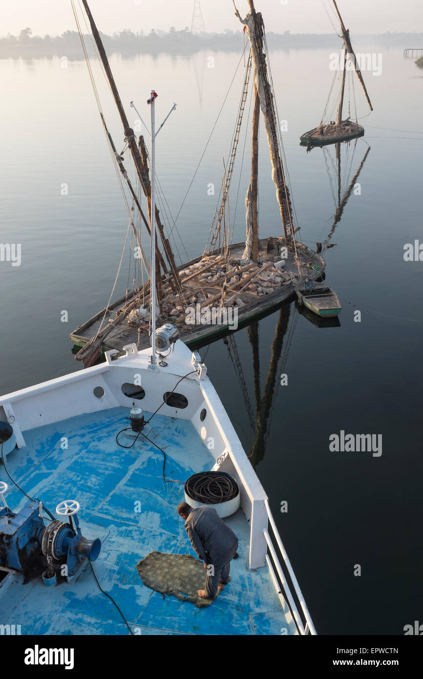 Deckhand on a cruise ship performs morning prayer at sunrise on the ...
