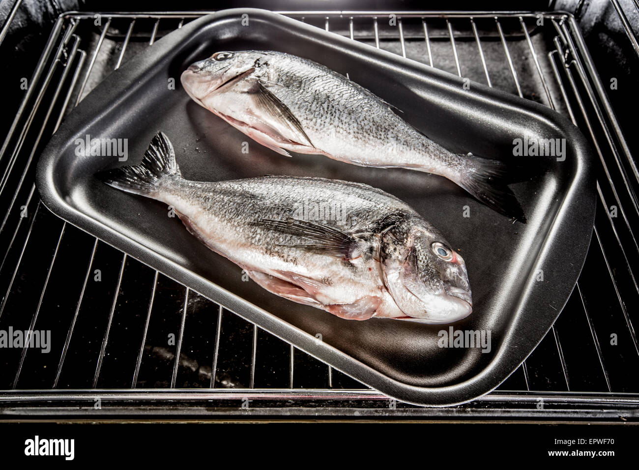 Dorado fish Cooking in the oven Stock Photo - Alamy