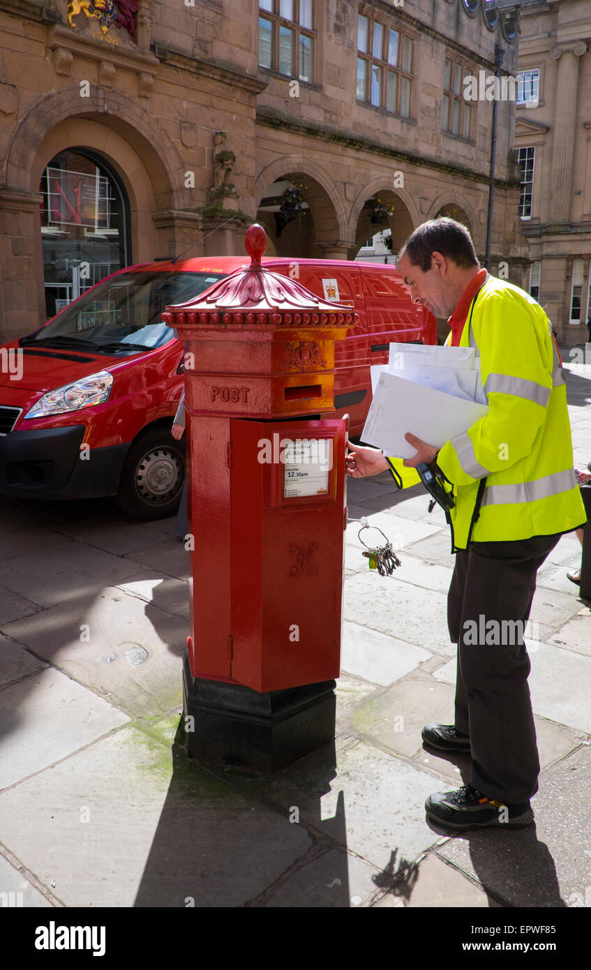 Postman collecting post from a Penfold pillar box in the Square ...