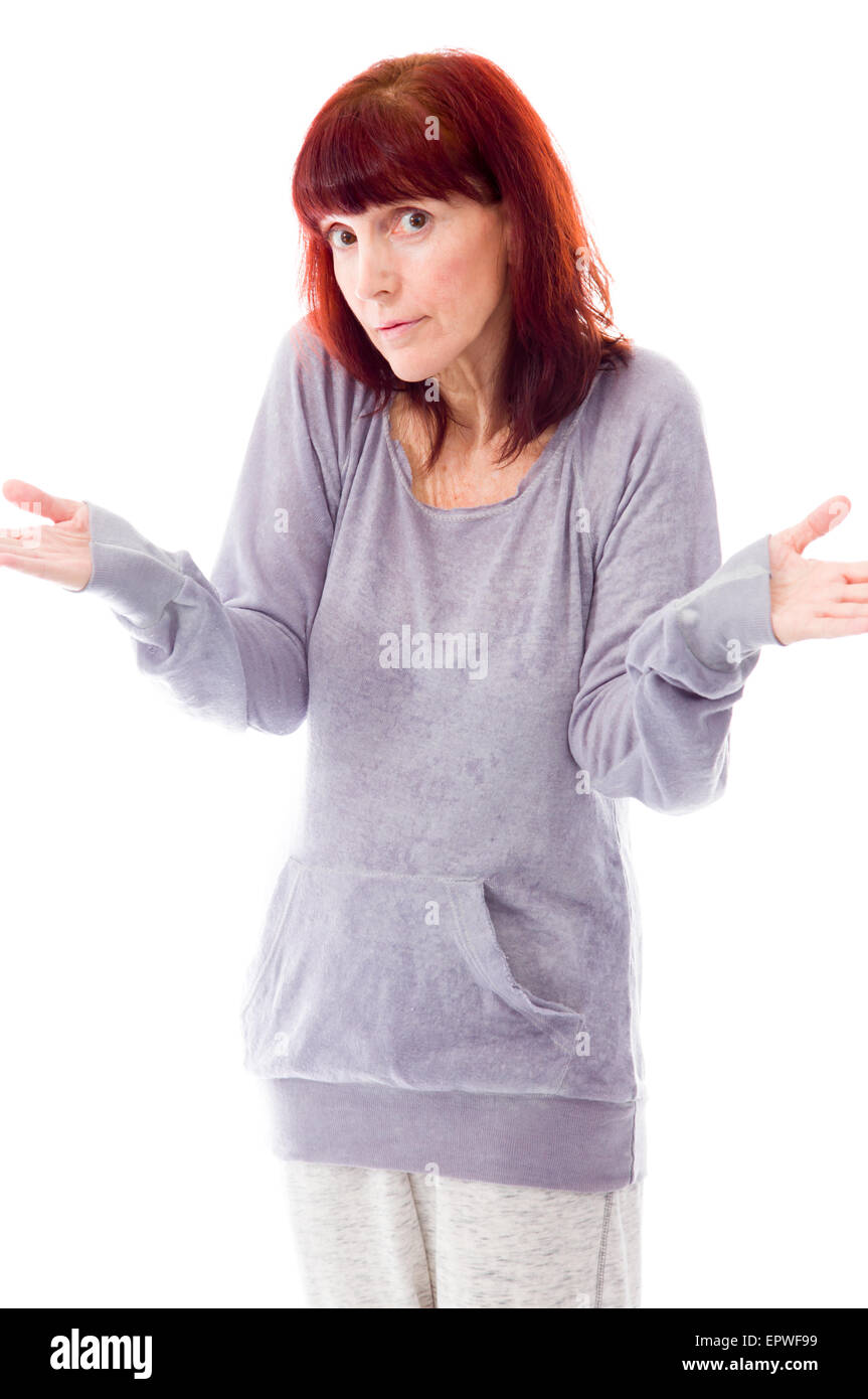 Mature woman looking confused and presenting something Stock Photo - Alamy