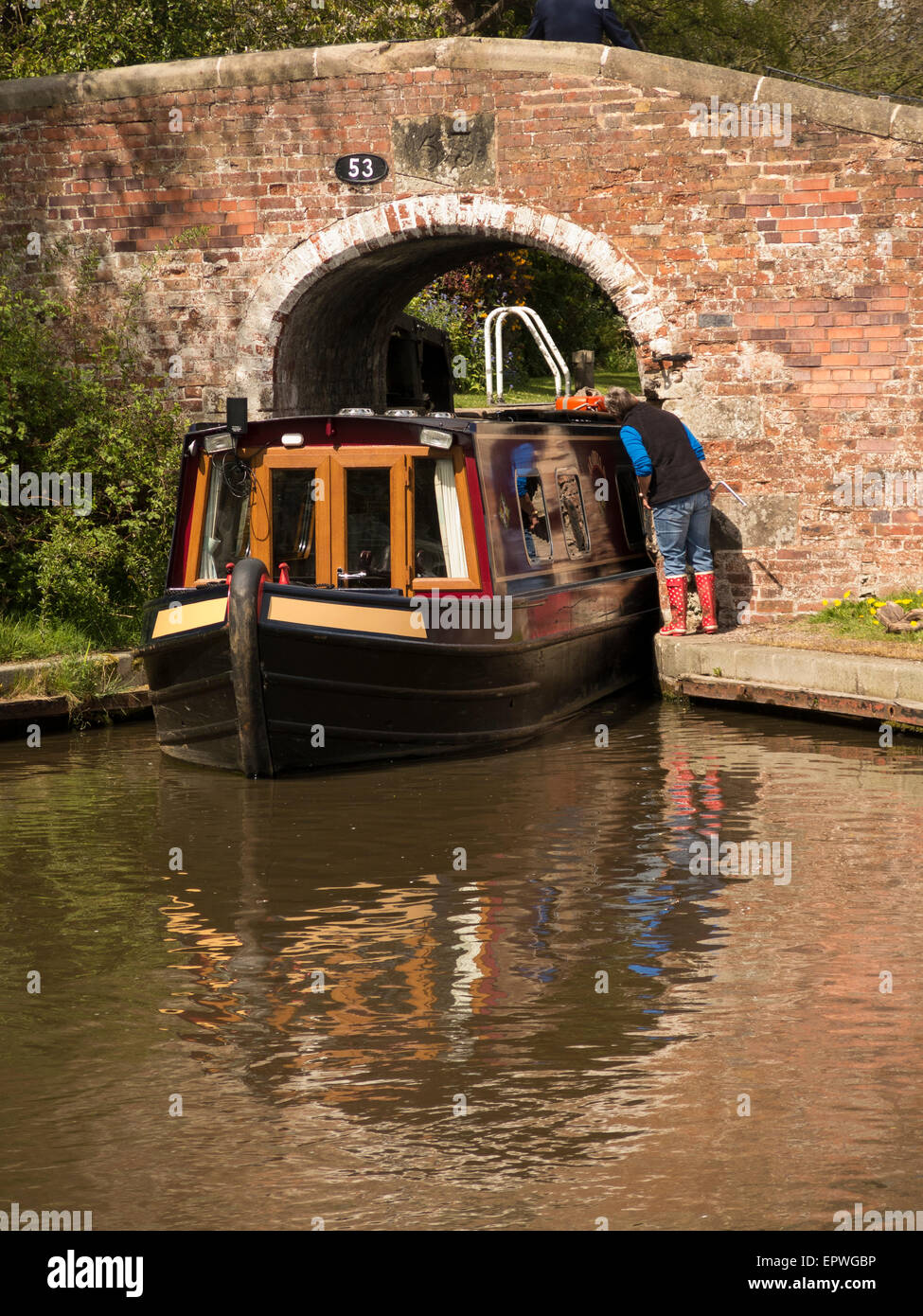 a narrow boat goes through Bridge 53 on The Trent & Mersey canal ...