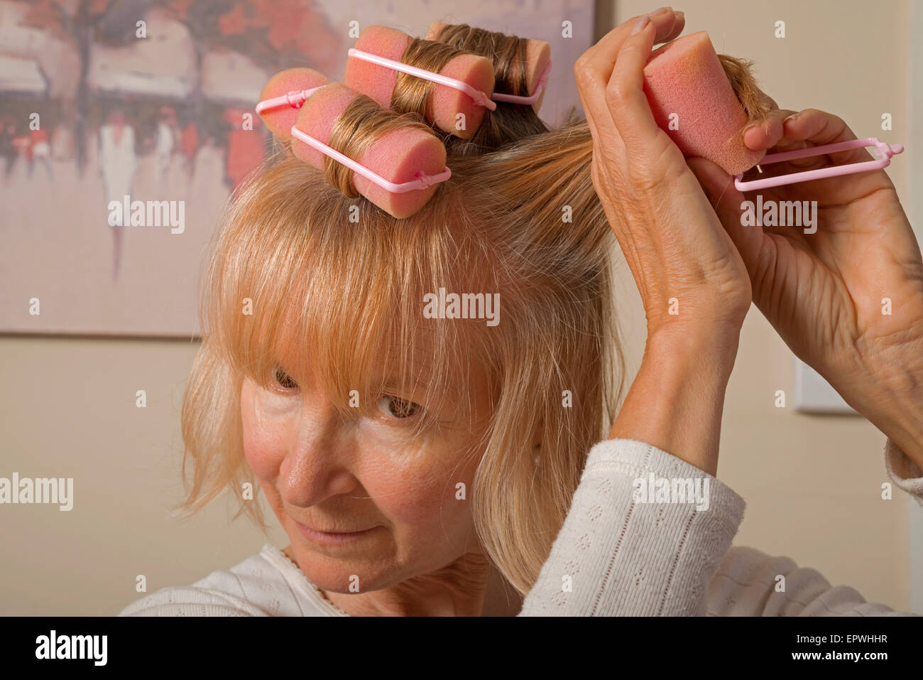 Lady curling her hair home hi-res stock photography and images - Alamy