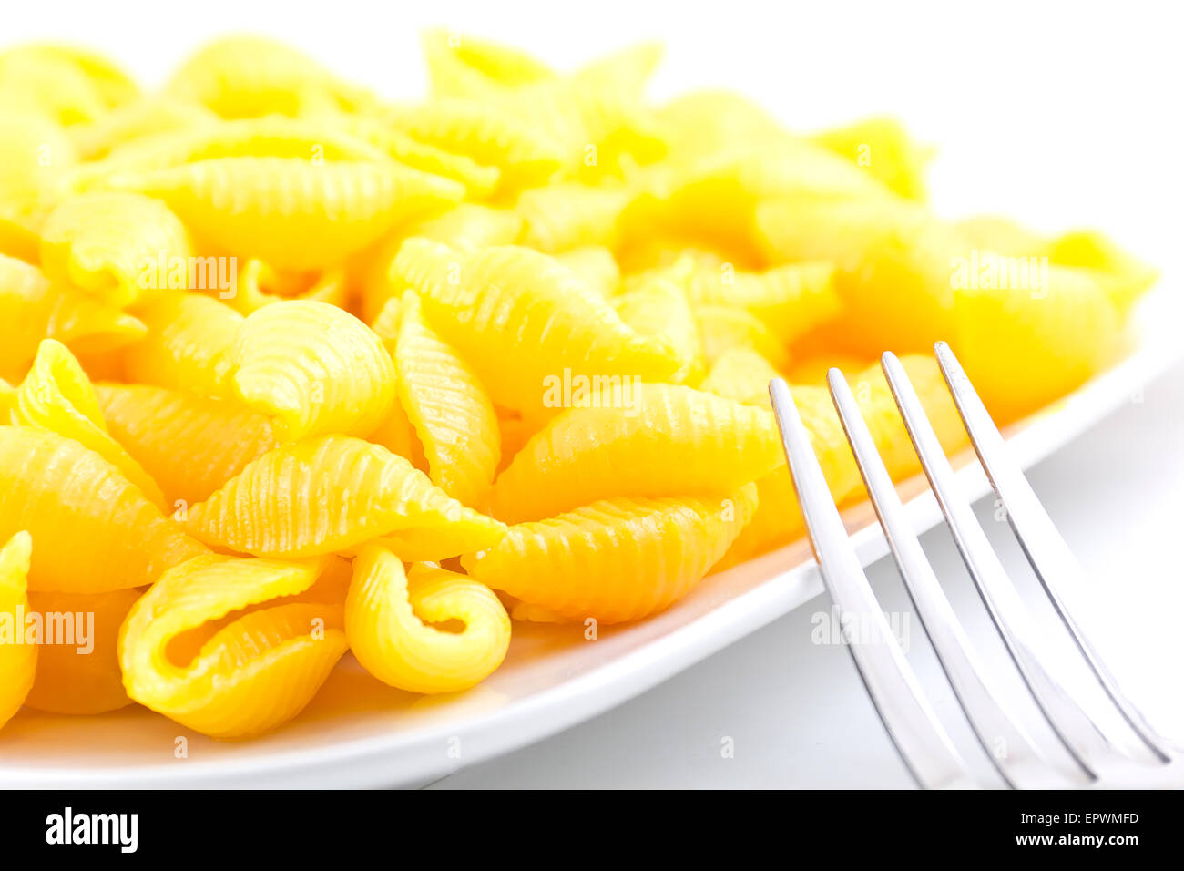 Macaroni and cheese made with shell pasta isolated on a white ...