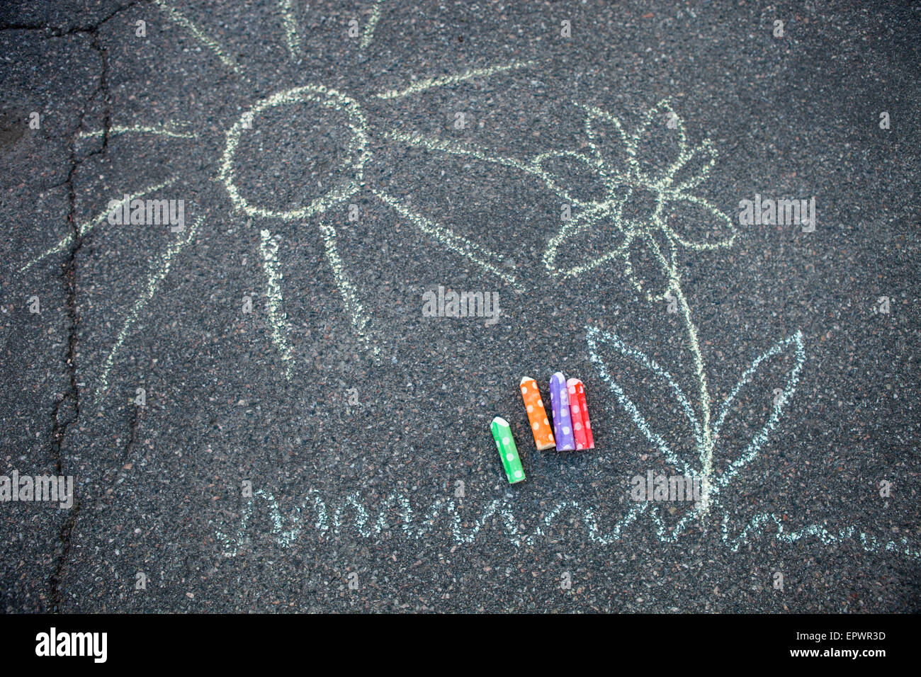 Sun and flower drawn to asphalt with colorful street chalk Stock Photo ...