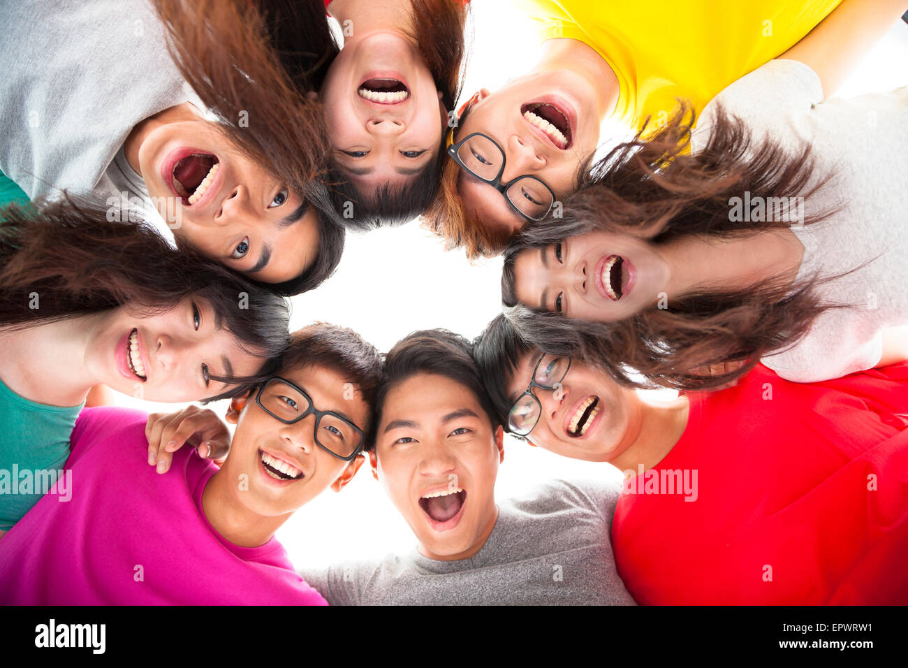 Group of happy young student with arms around each others shoulders ...