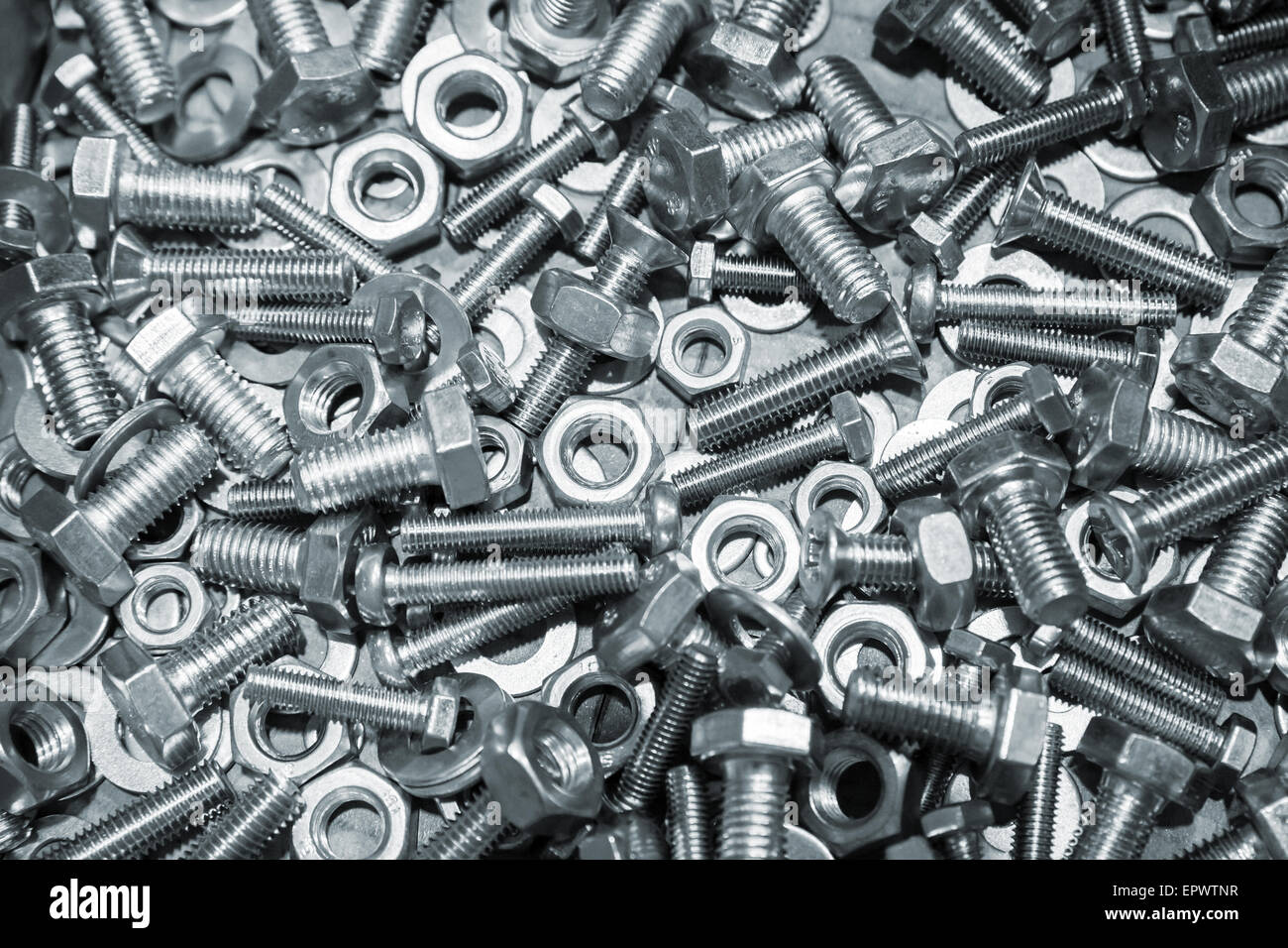 Shining bolts and nuts, blue toned photo background with selective ...