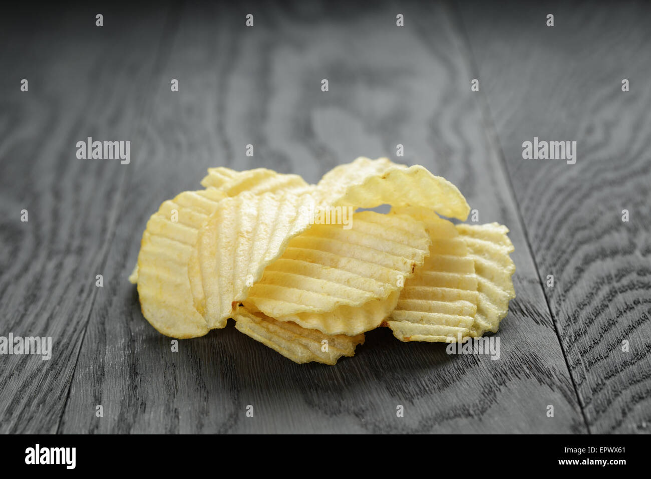 rippled organic chips on wooden table Stock Photo - Alamy
