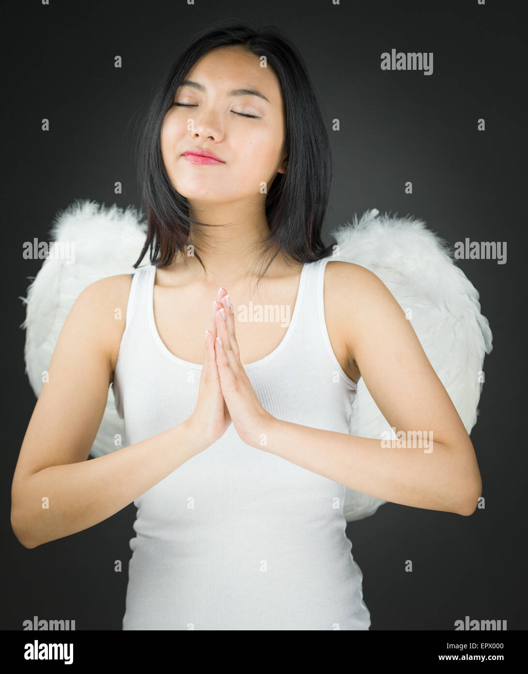 Attractive Asian young adult woman in angels and demon Stock Photo - Alamy