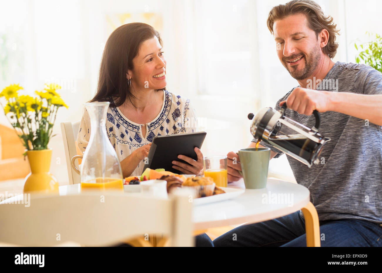 Couple talking at table Stock Photo - Alamy