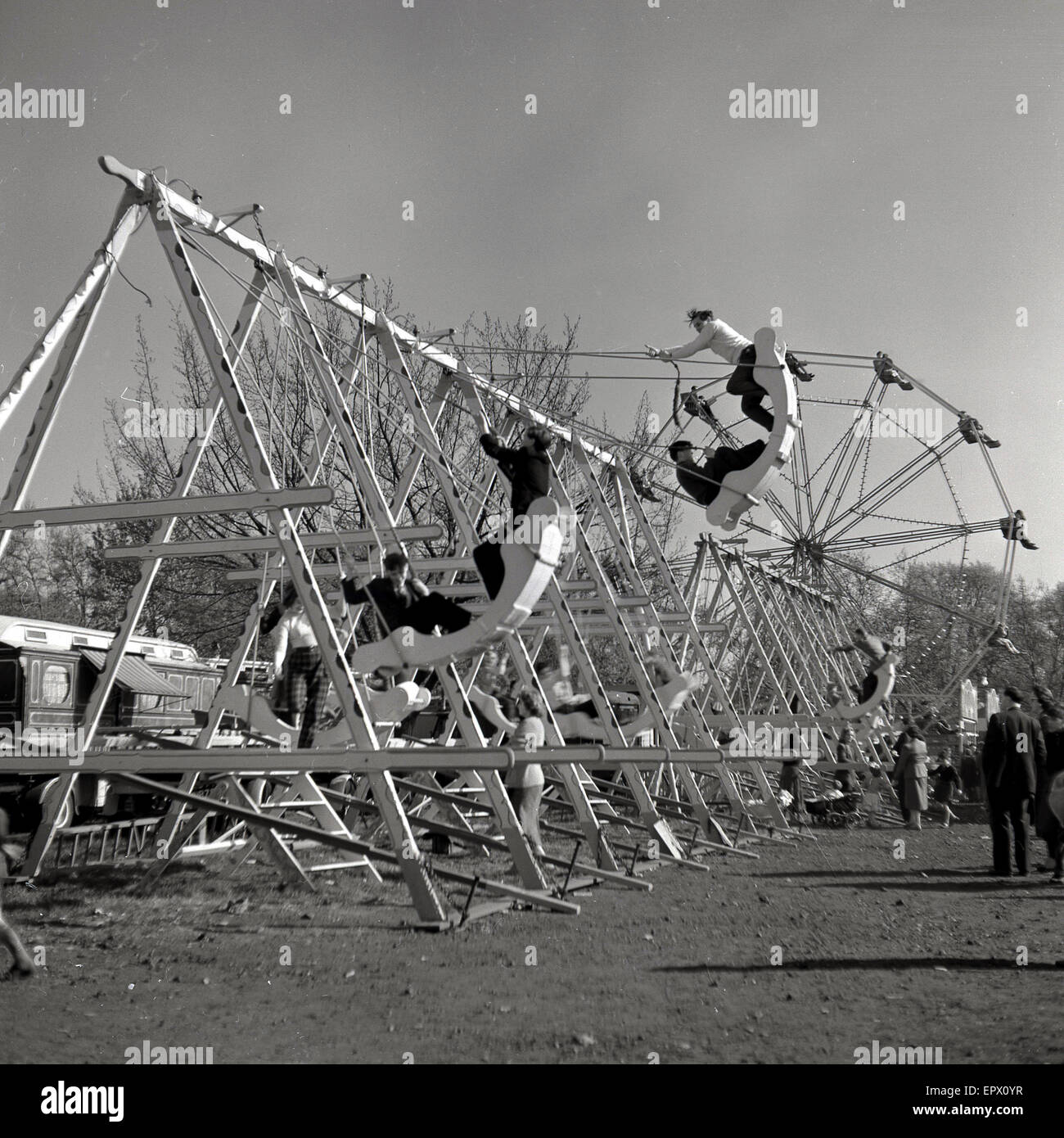 1950s, historical, people at a fairground or funfair on a fast moving ...