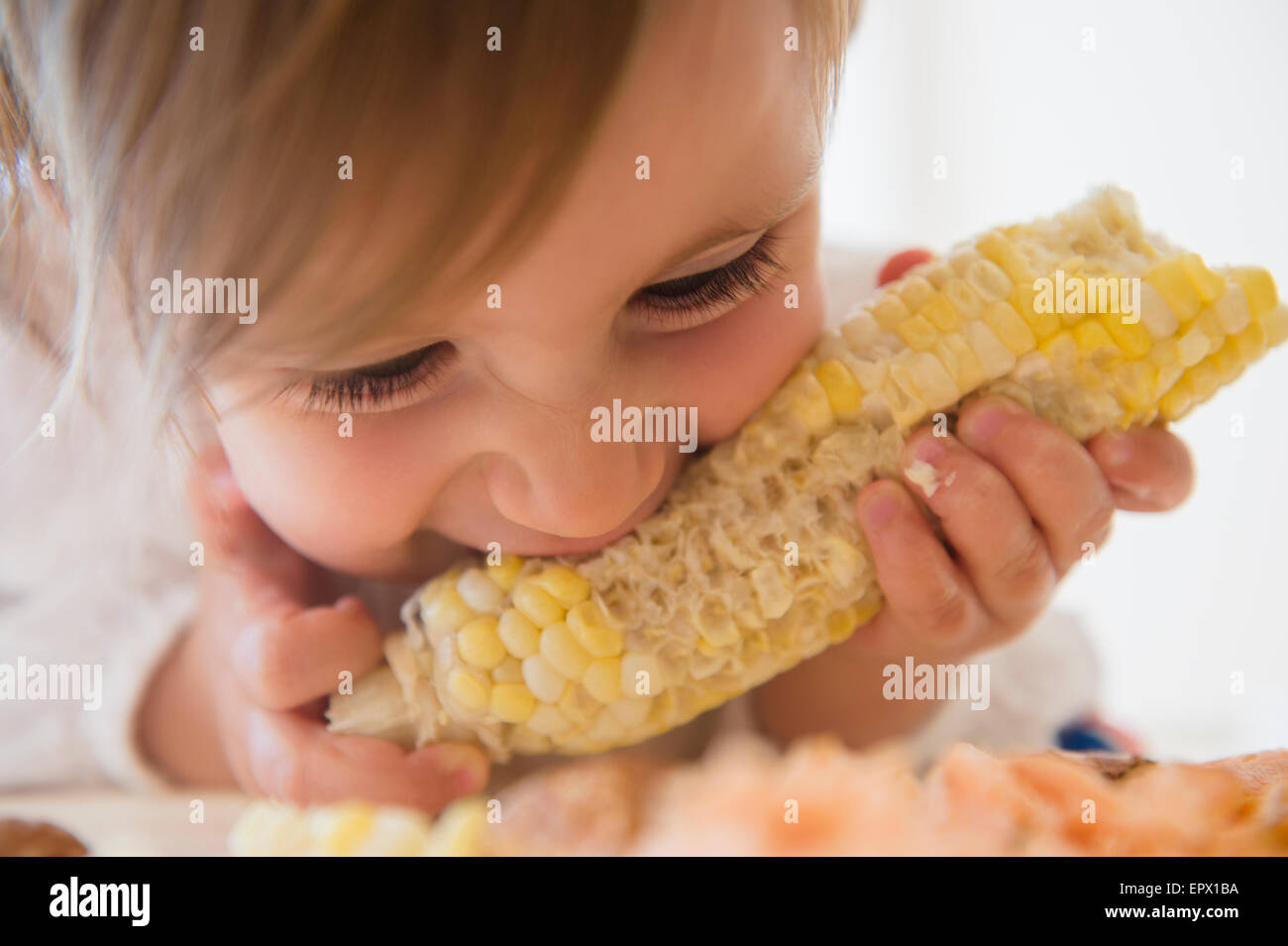 Girl eating sweet corn hi-res stock photography and images - Alamy